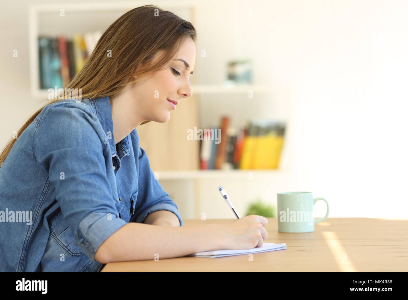 Woman writing a note hi-res stock photography and images - Alamy