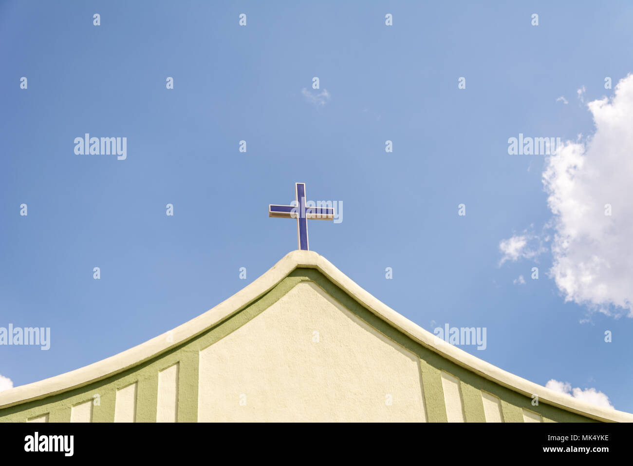 the cross in the front of a church against a clear sky Stock Photo - Alamy