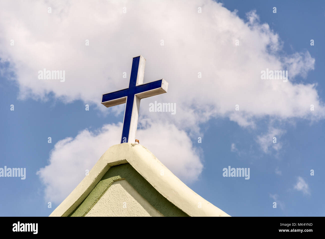 the cross in the front of a church against a clear sky Stock Photo - Alamy