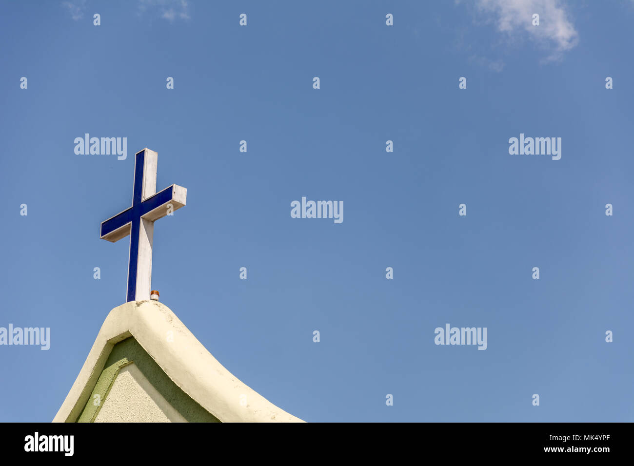 the cross in the front of a church against a clear sky Stock Photo - Alamy