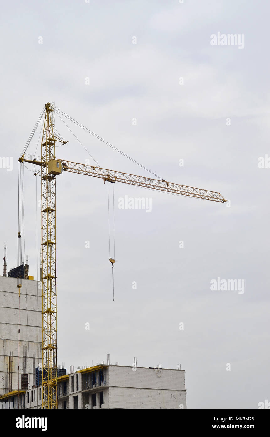 Working tall cranes inside place for with tall buildings under ...