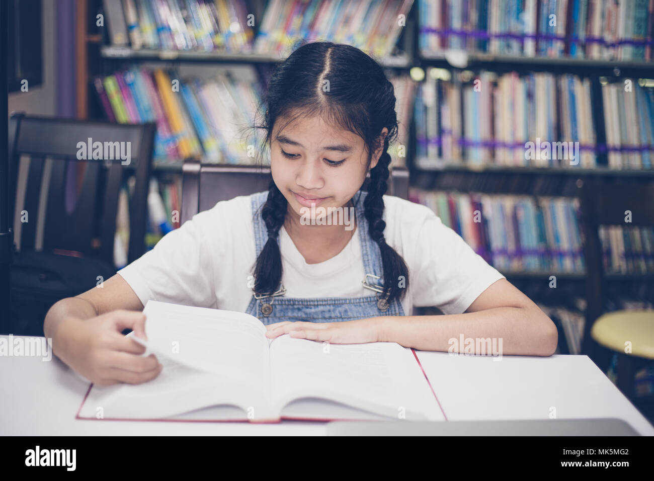 Asian students reading books in the library Stock Photo - Alamy