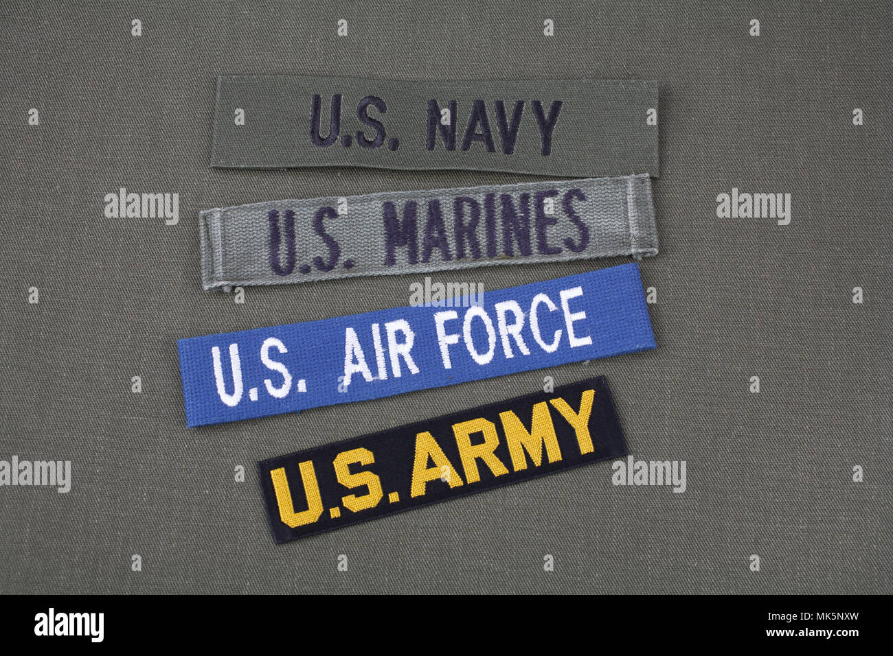 US military concept on olive green uniform background Stock Photo - Alamy