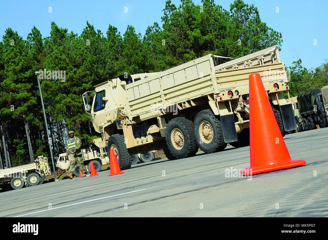 A Light Medium Tactical Vehicle driver manuevers around the course ...