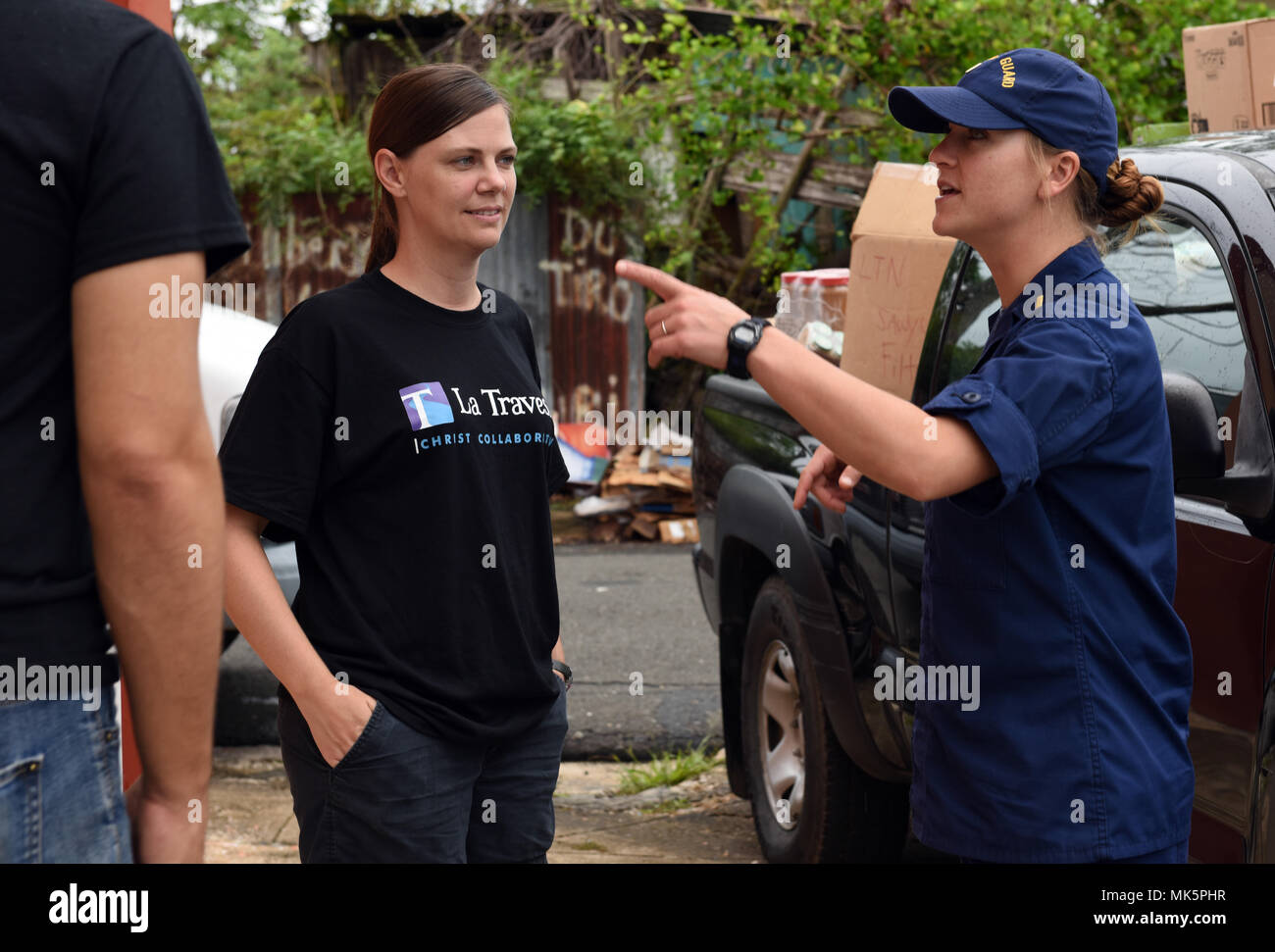 U.S. Coast Guard Ens. Shaina Moore speaks with a group of local ...