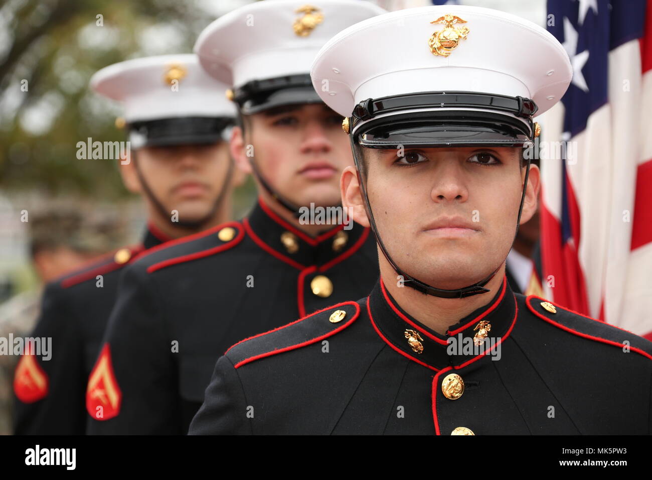 U.S. Marines with color guards from various units stand in position ...