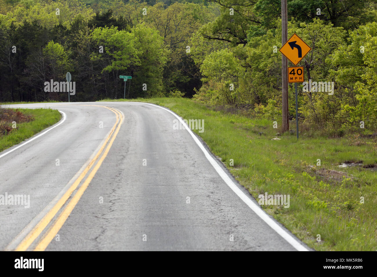 Winding road through the woods Stock Photo - Alamy