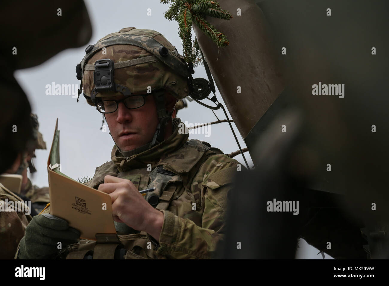 U.S. Army 1st Lt. Keven Fleming of the 2nd Cavalry Regiment takes notes ...