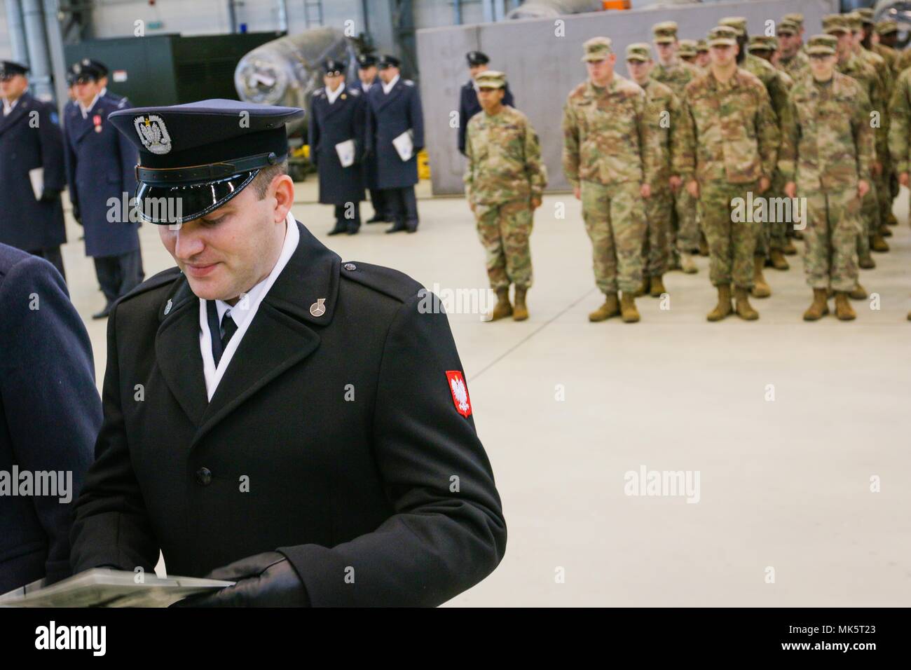 A Polish airman (left) with the 3rd Airlift Wing is promoted in front ...