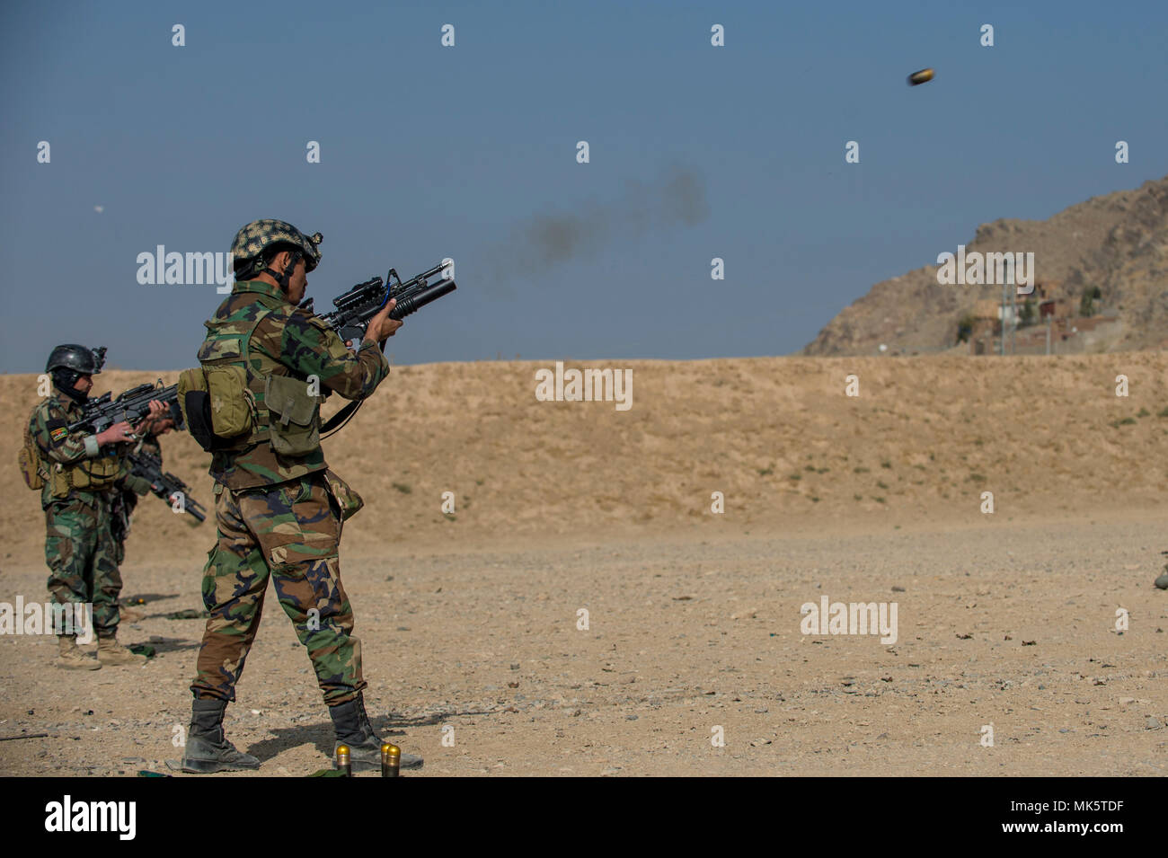 An M203 round leaves the barrel of an Afghan Commando's grenade ...