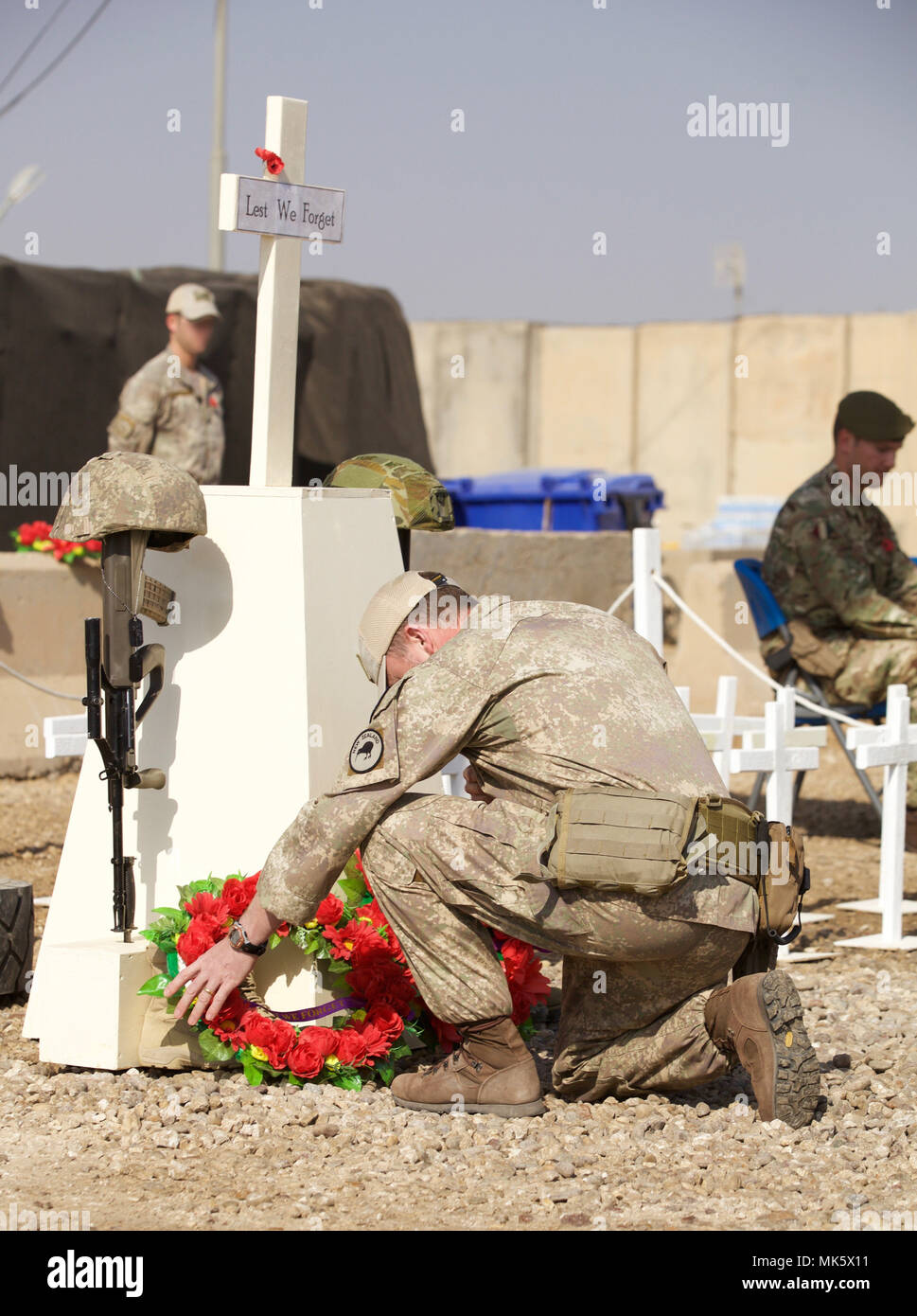 A New Zealand soldier lays a wreath on a memorial commemorating ...