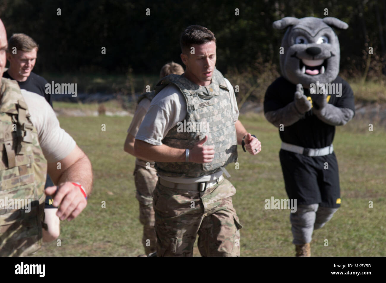 Sgt. Rocky, 3rd Infantry Division's mascot, runs with and cheers on a ...