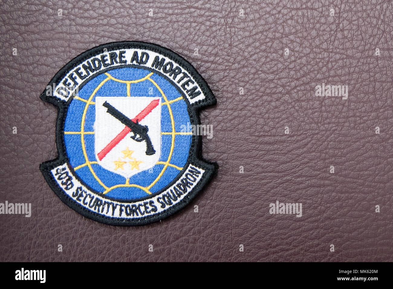 The 403rd Security Forces Squadron unit patch rests on a chair at ...