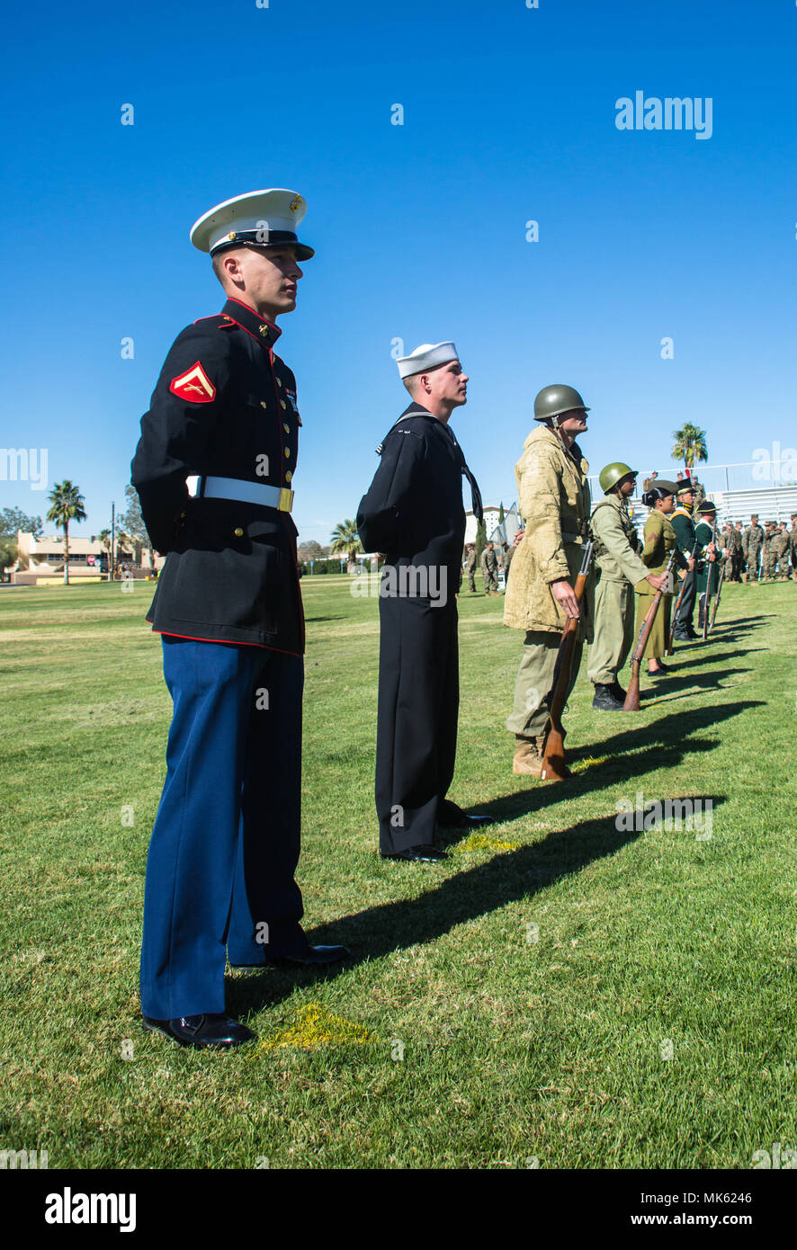 The historically uniformed Marines stand at parade rest during the ...