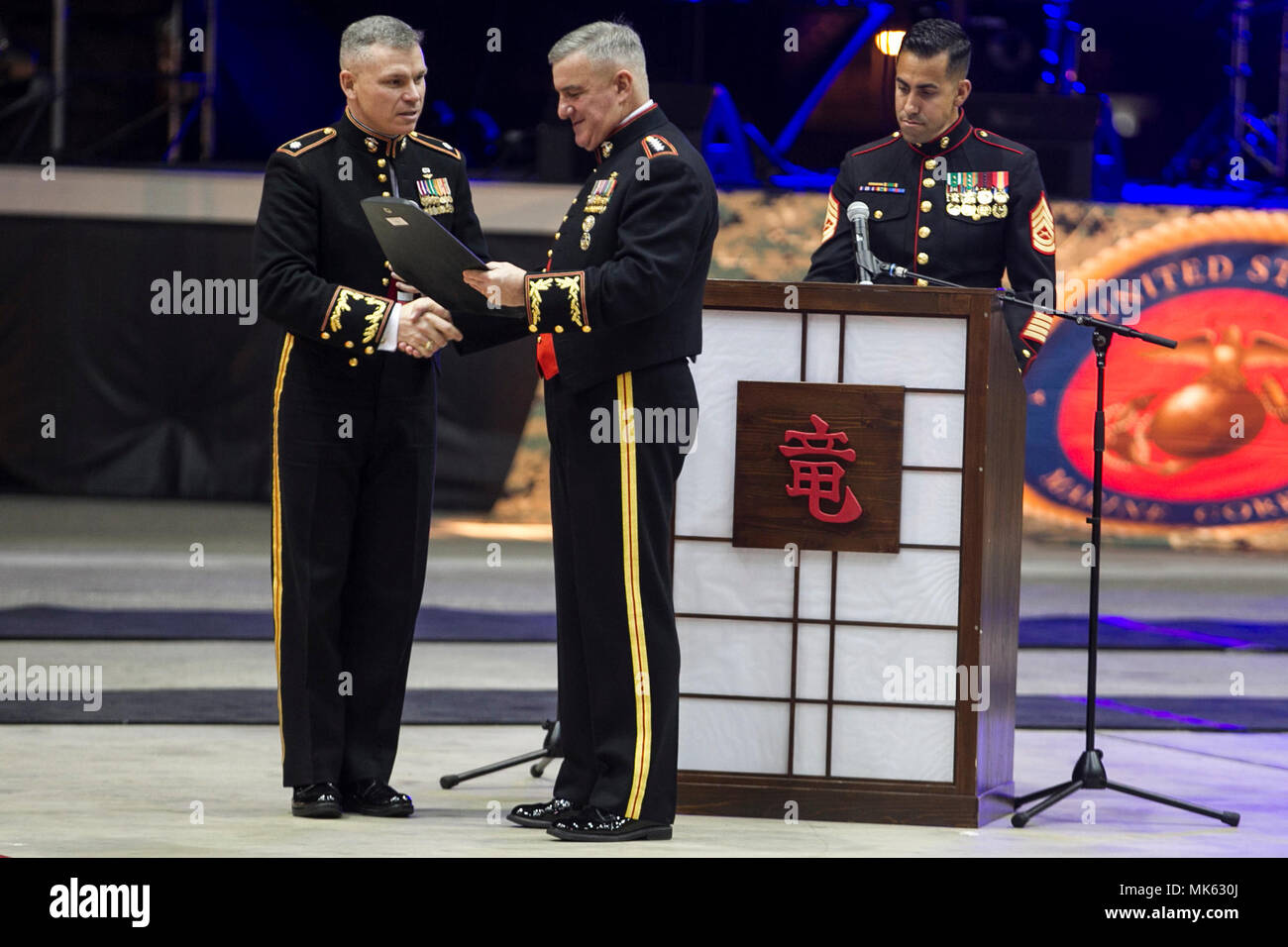 Lt. Col. Bryan G. Swenson presents a commemorative plaque to Gen. Glenn ...