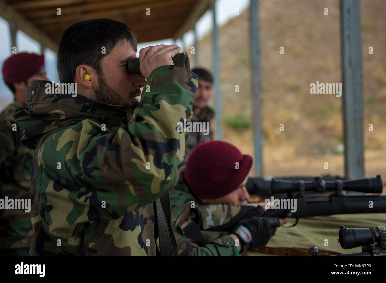 AN Afghan Commando provides immediate feedback to assist his partner ...