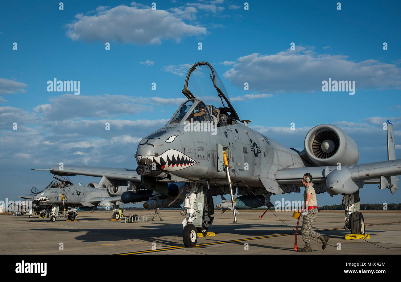 Preflight checks begin down the line of fighter aircraft before morning ...