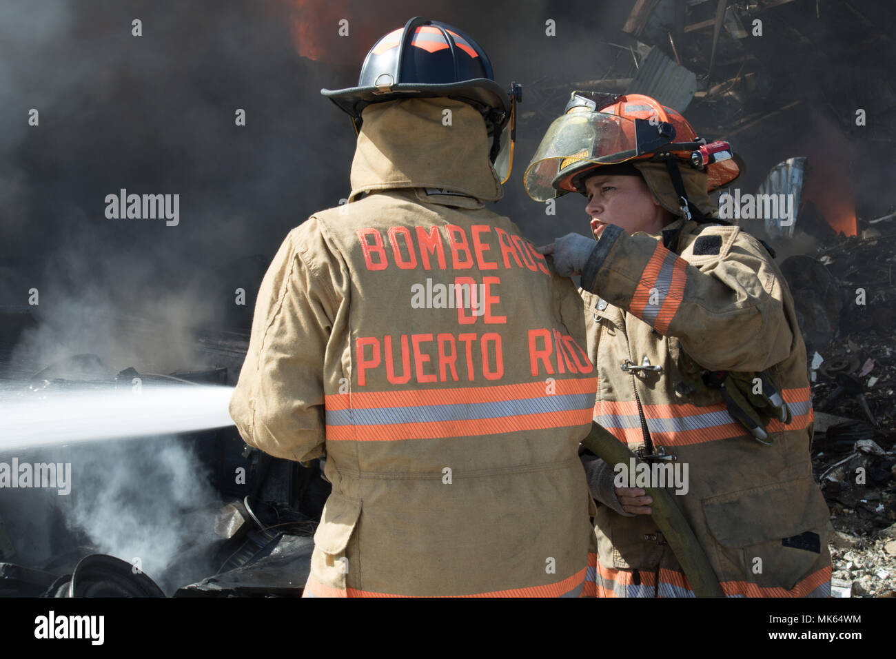 SAN JUAN, Puerto Rico – Firefighters battle a blaze at Homeca Recycling ...