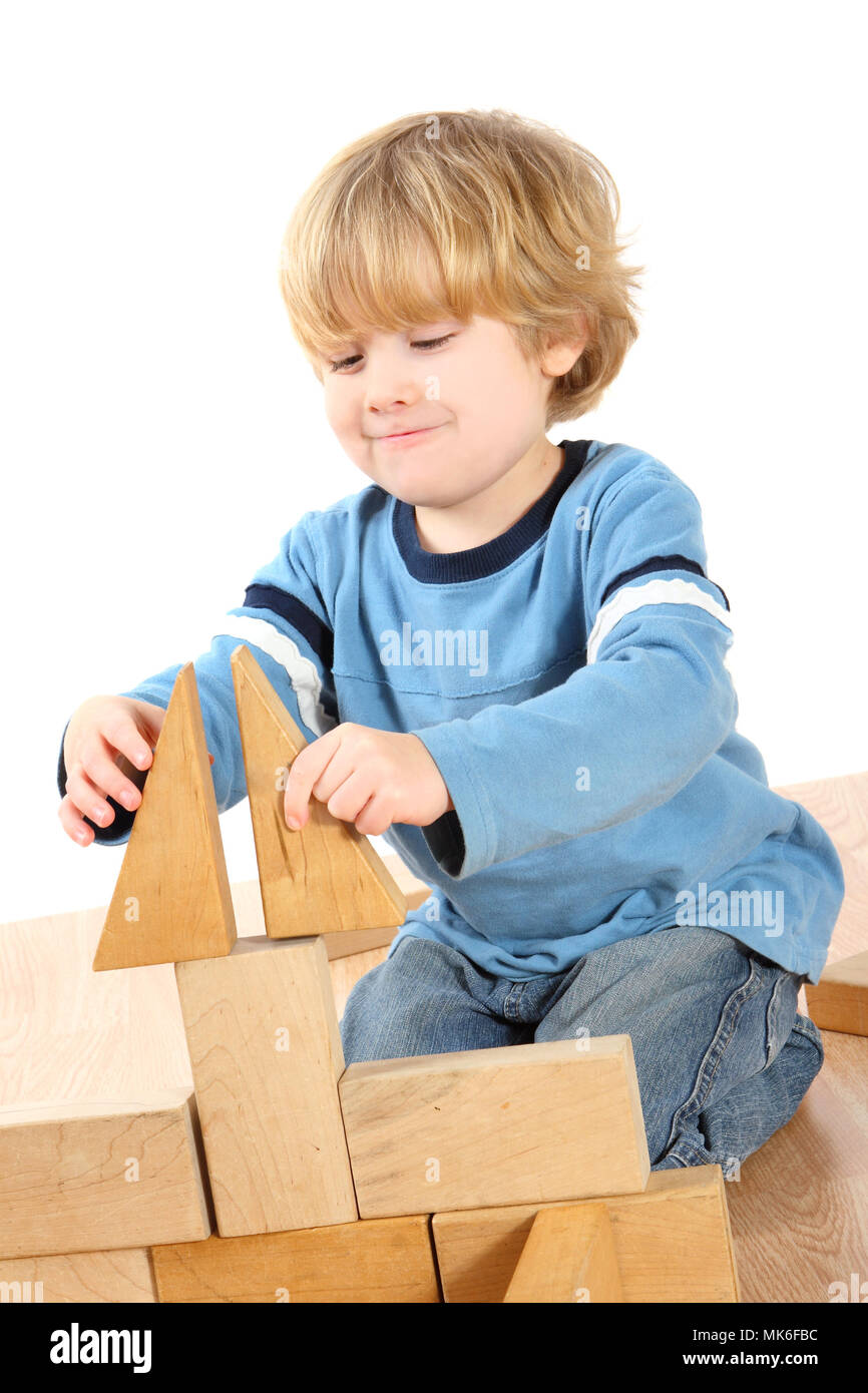Young boy playing with wooden building blocks Stock Photo - Alamy