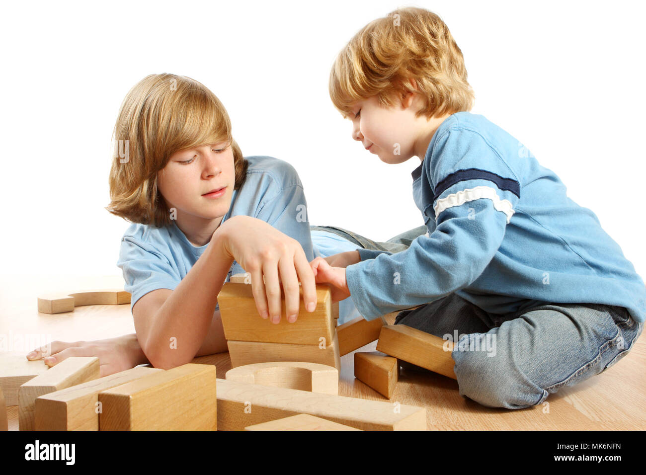 two brothers playing with wooden blocks Stock Photo - Alamy