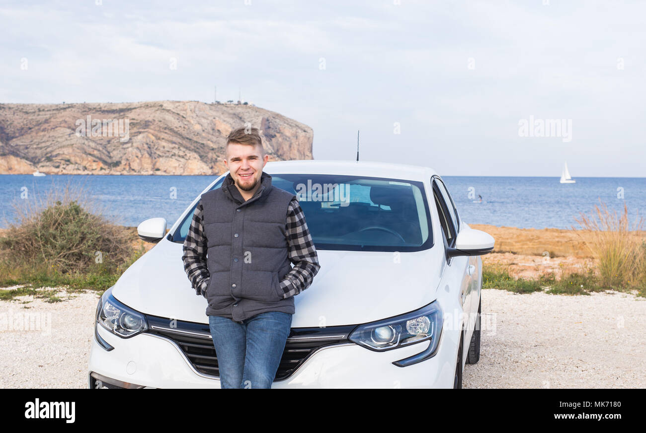 Handsome man standing in front of white car Stock Photo - Alamy