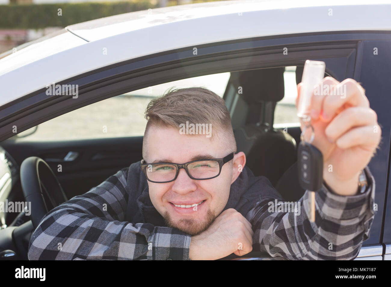 Young man hold key in white car Stock Photo - Alamy