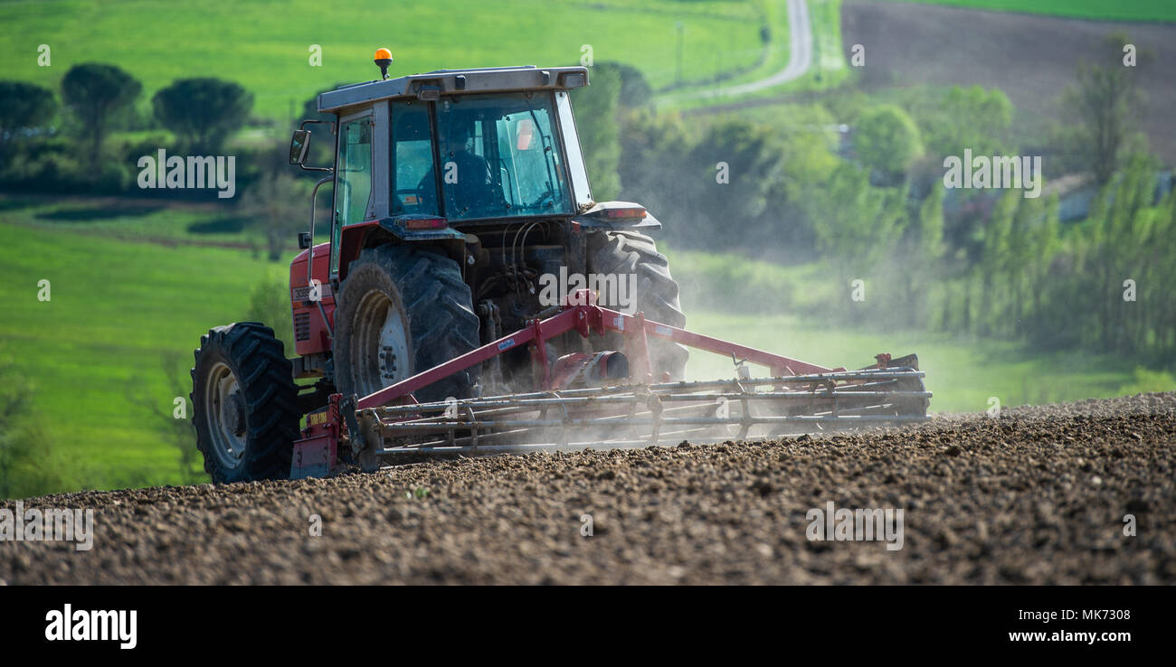 Tractor plowing field and beautiful landscape, France, Europe Stock ...