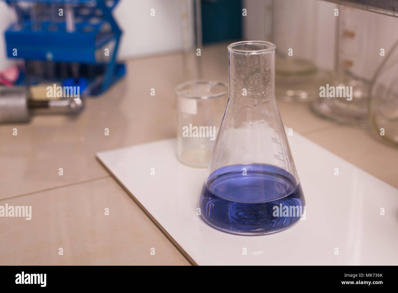 Laboratory flask with blue liquid Stock Photo - Alamy