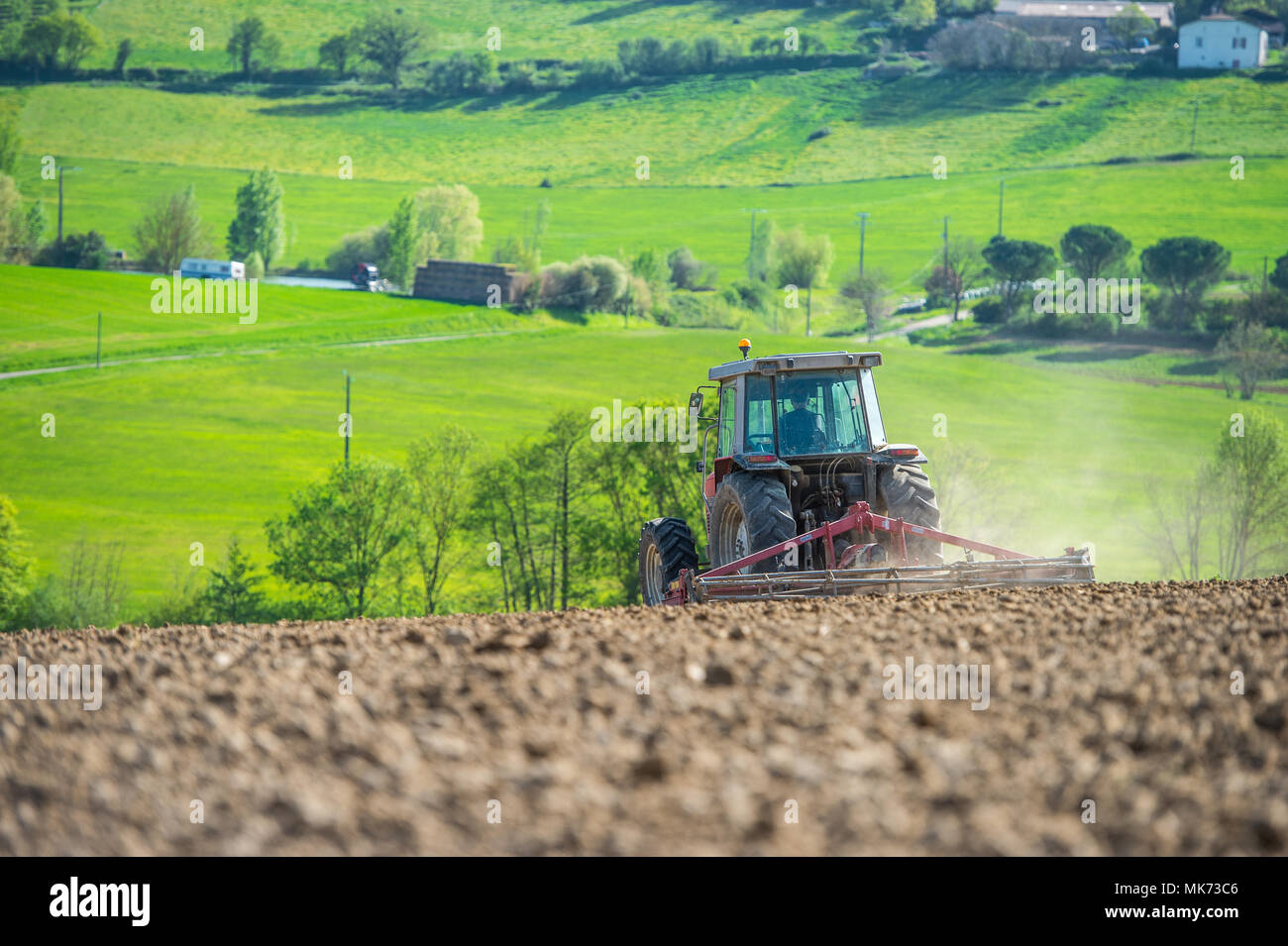 Tractor plowing field and beautiful landscape, France, Europe Stock ...