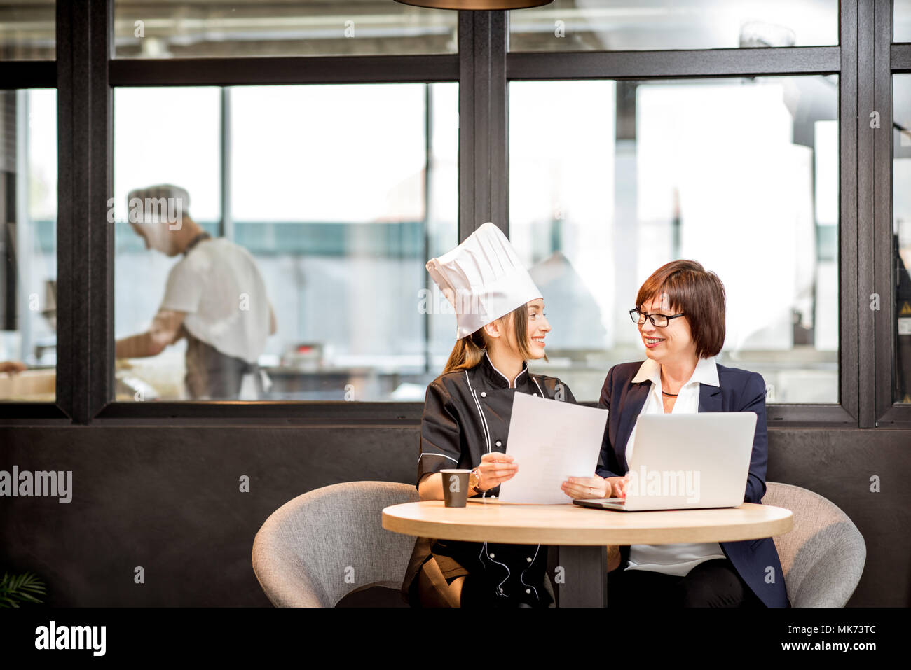 Senior chef and young cook at the restaurant Stock Photo - Alamy
