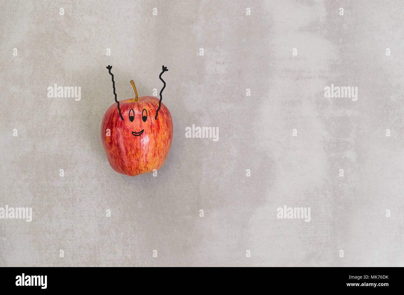 Great concept of healthy eating, apple with happy face and arms upwards ...