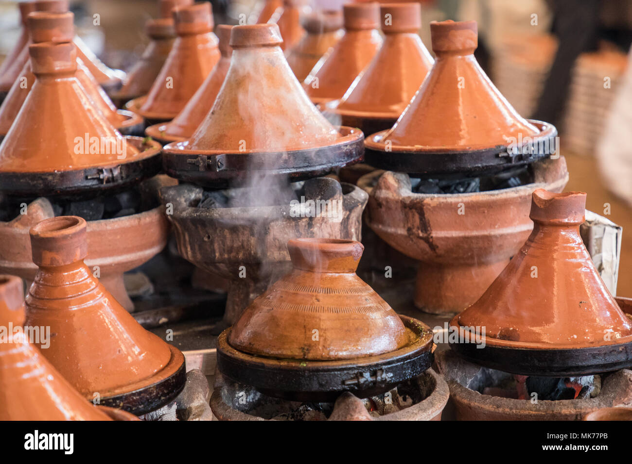 Preparing food in tajin traditional dish in Morocco - meat and ...