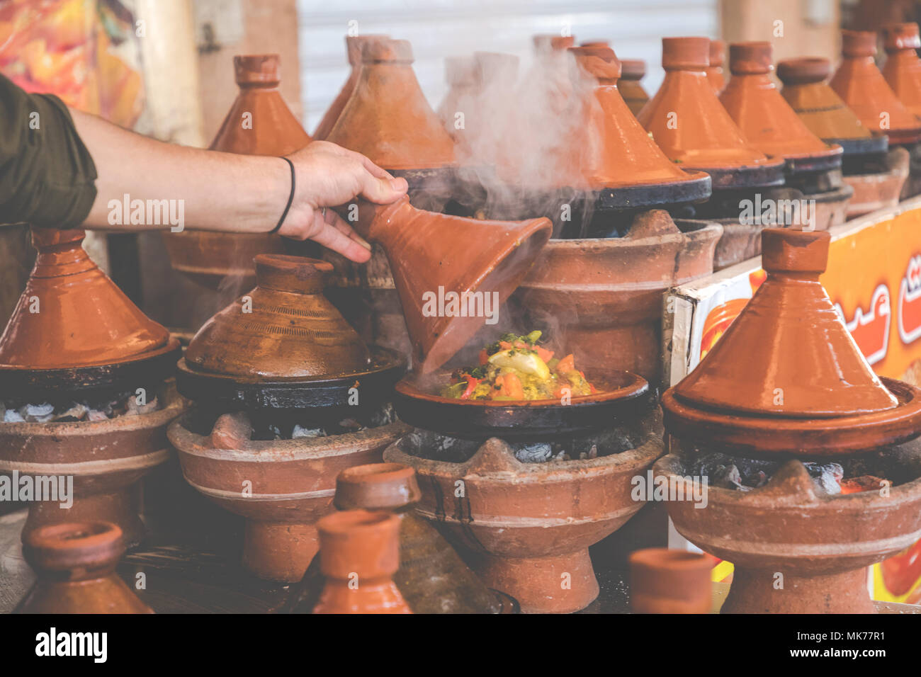 Preparing food in tajin traditional dish in Morocco - meat and ...