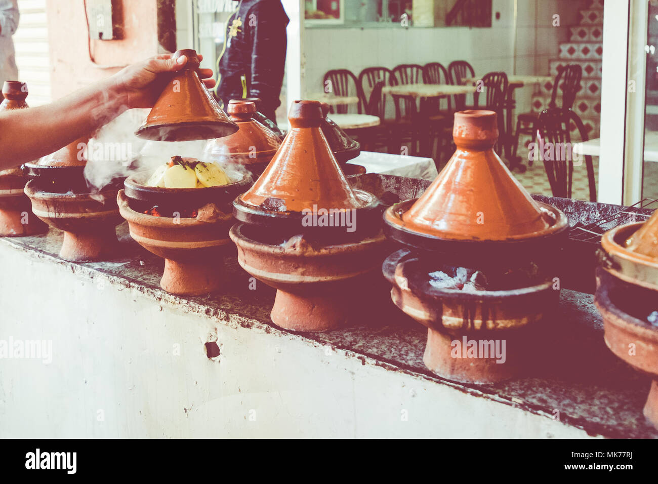 Preparing food in tajin traditional dish in Morocco - meat and ...