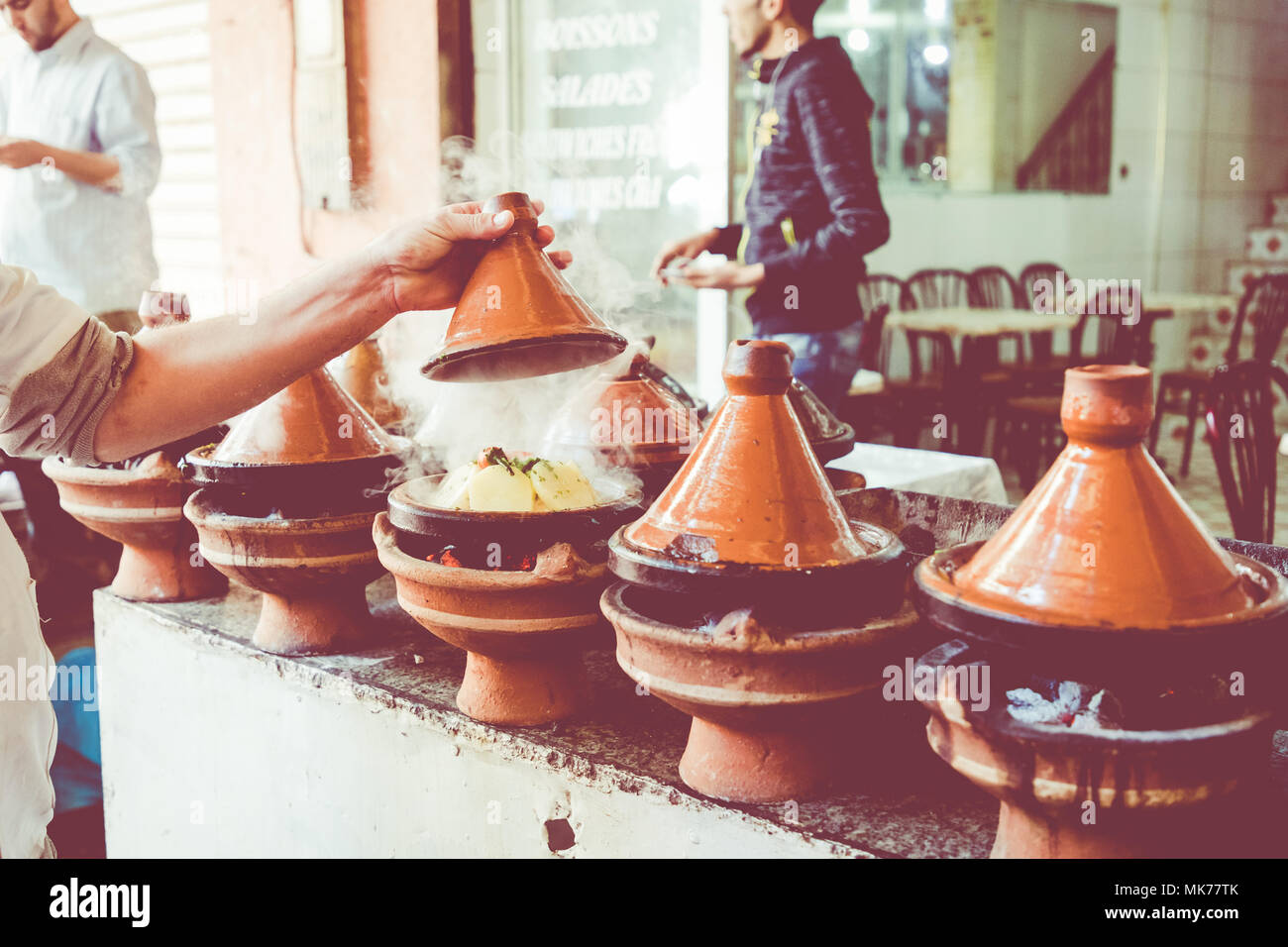 Preparing food in tajin traditional dish in Morocco - meat and ...