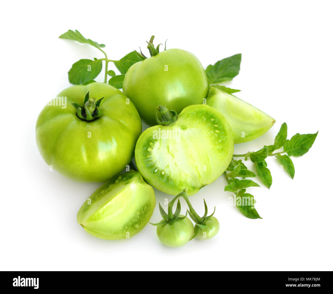 Green unripe tomatoes. Isolated on white background Stock Photo - Alamy