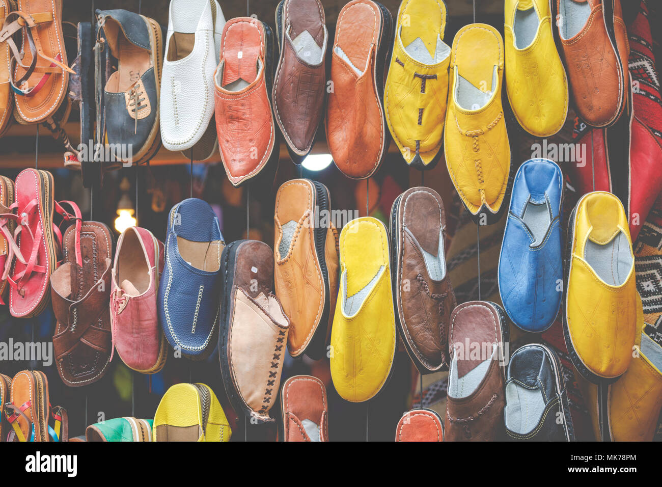 Moroccan leather goods bags and slippers at outdoor market in Marrakesh ...