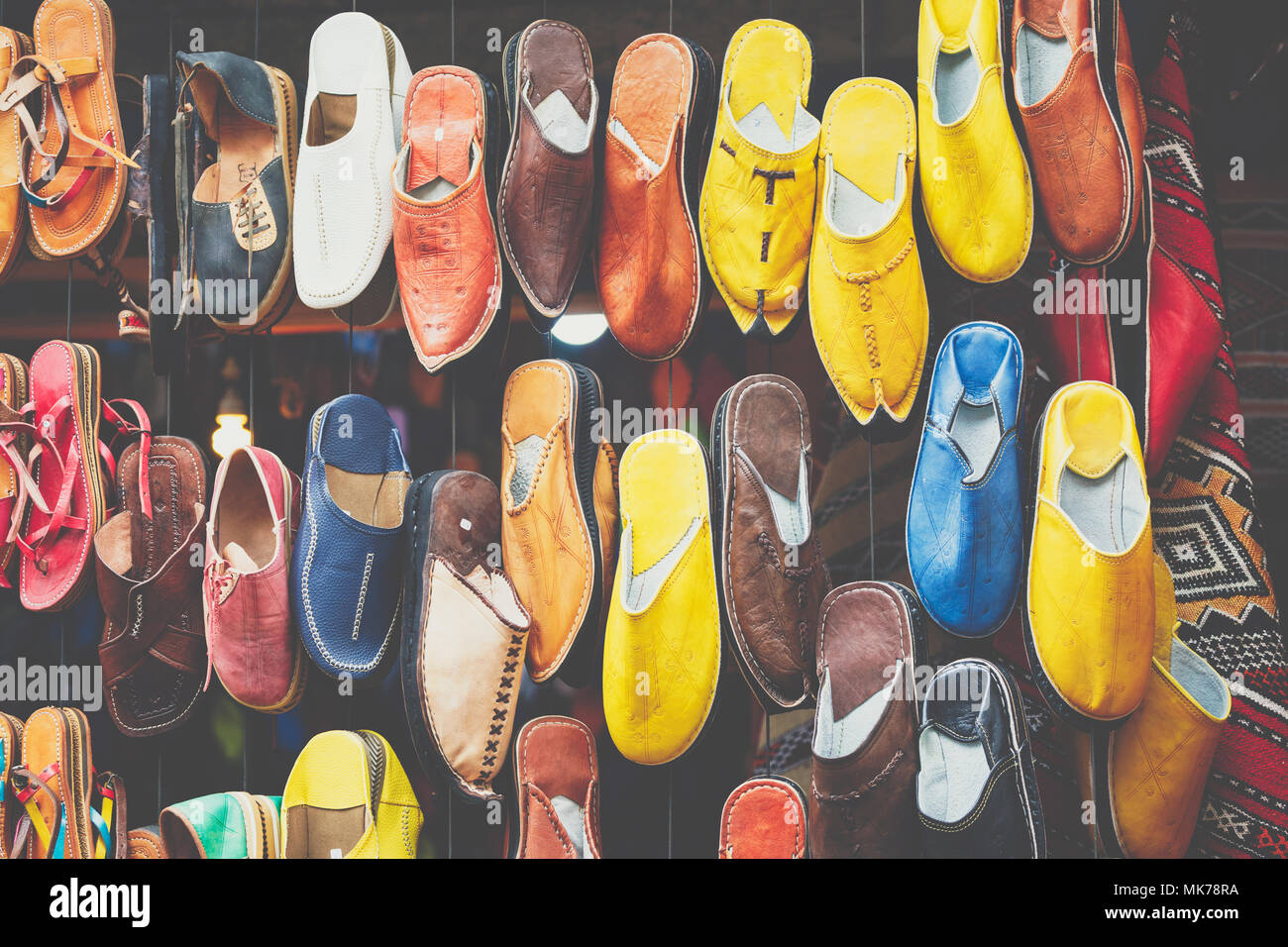 Moroccan leather goods bags and slippers at outdoor market in Marrakesh ...