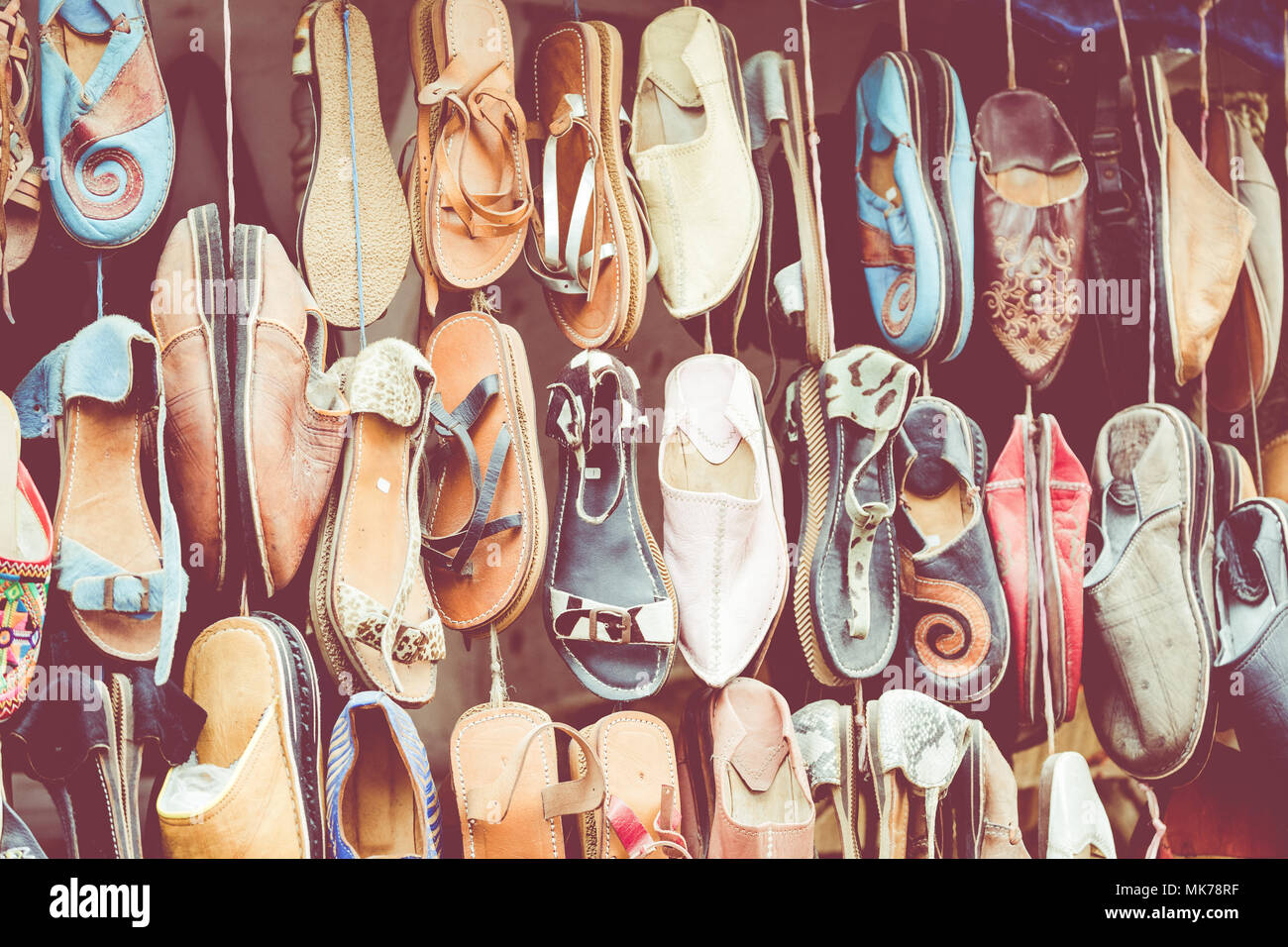 Moroccan leather goods bags and slippers at outdoor market in Marrakesh ...
