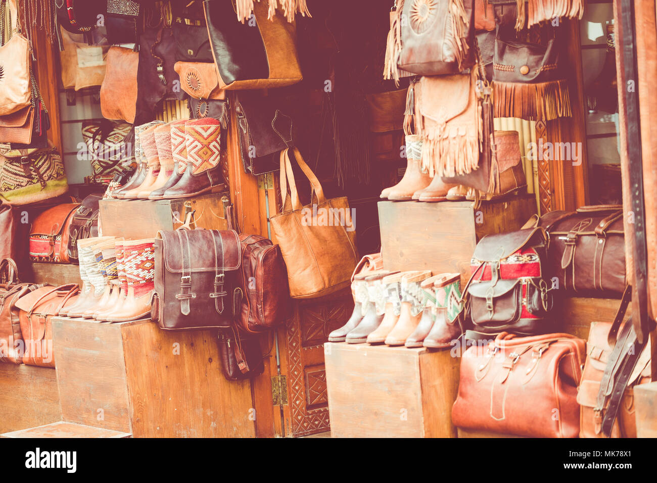 Moroccan leather goods bags and slippers at outdoor market in Marrakesh ...