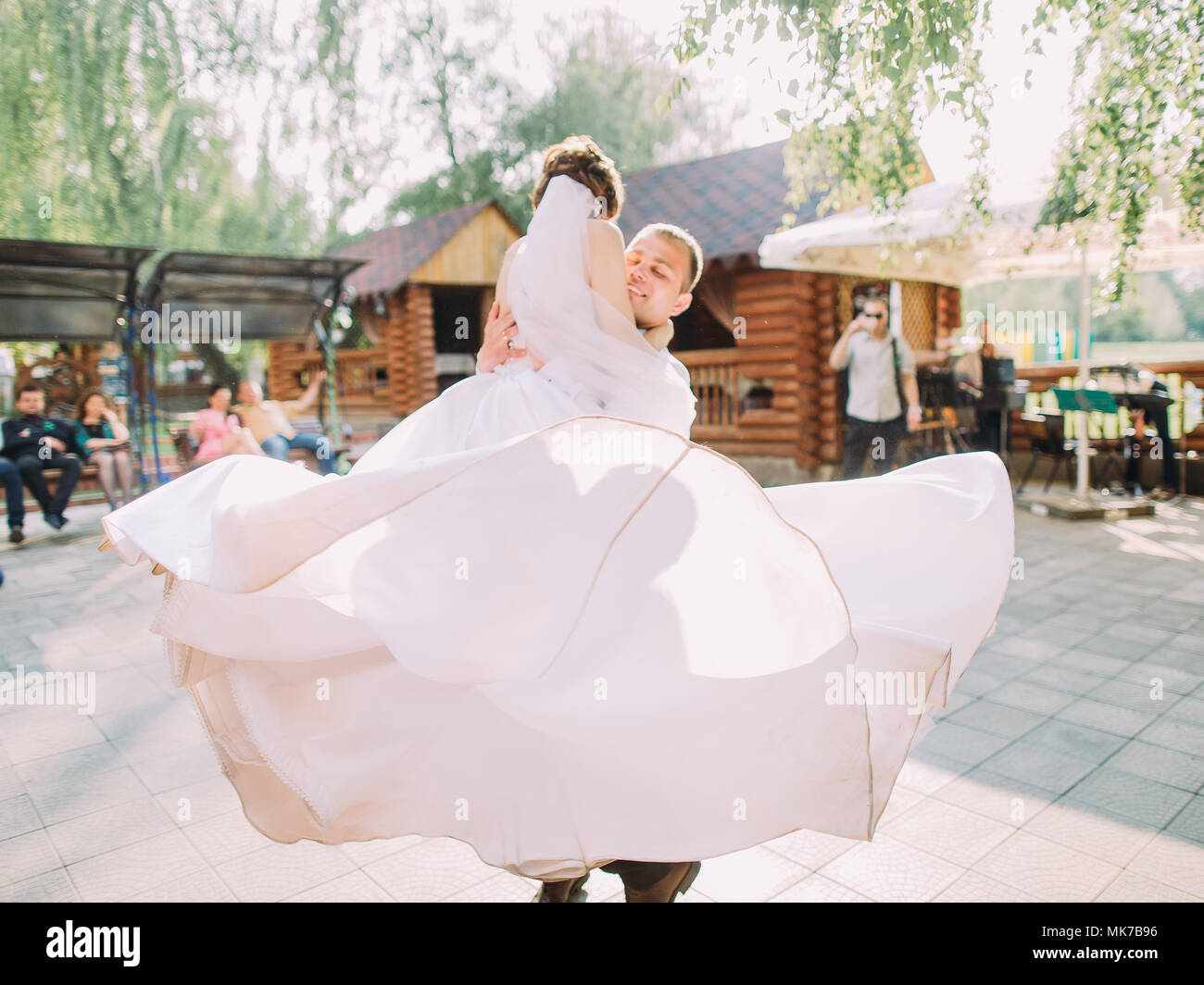 Groom is spinning the lovely bride in the long wedding dress Stock ...