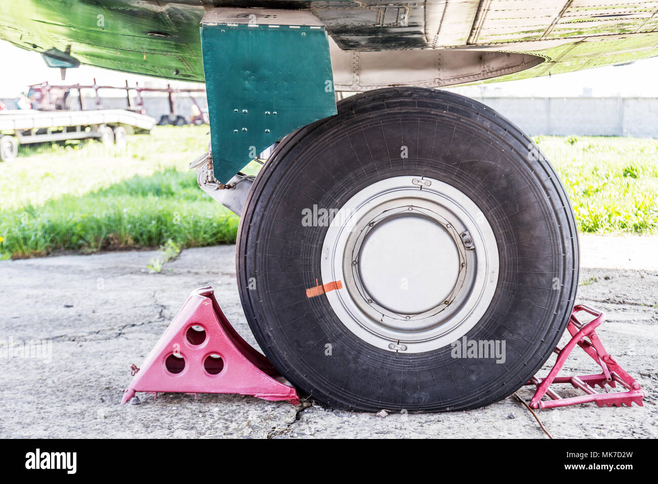 Side close-up view of air plane landing gear. Aircraft tyre wear and ...