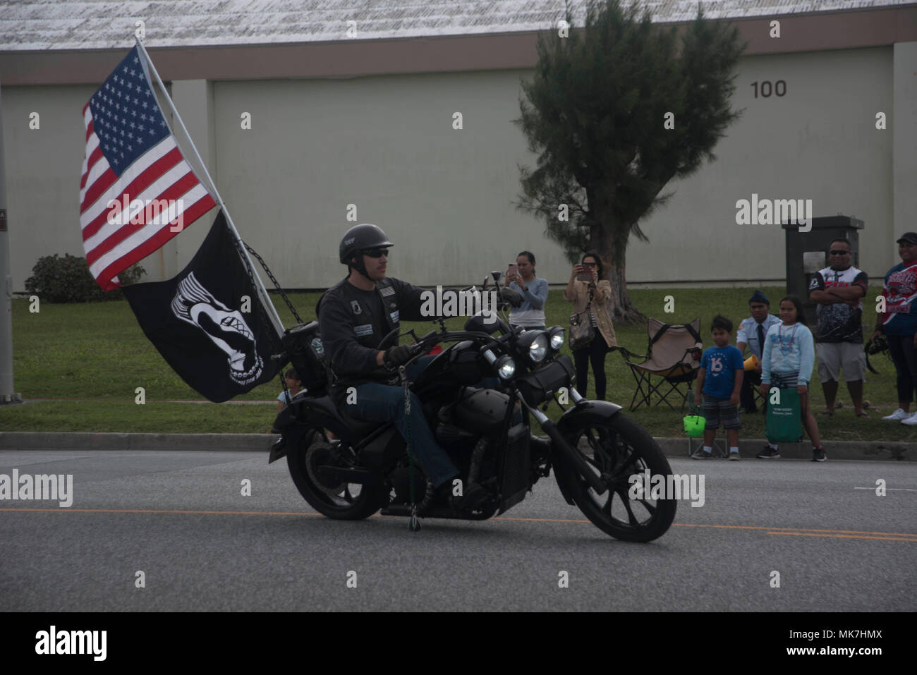 A motorcycle rider demonstrates safety skills during a parade Nov. 11 ...