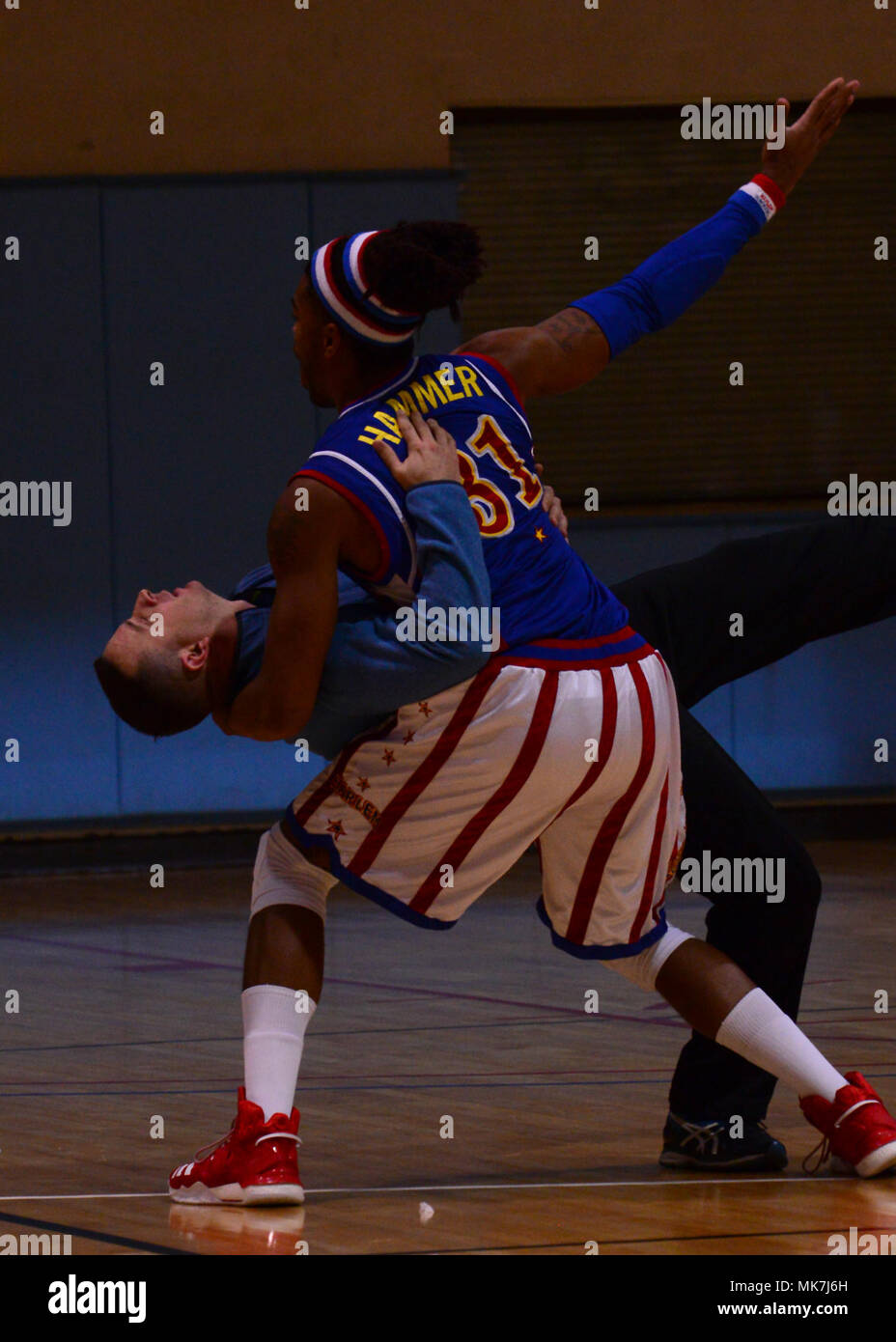 Hammer Harrison, member of the Harlem Globetrotters, dances with a ...