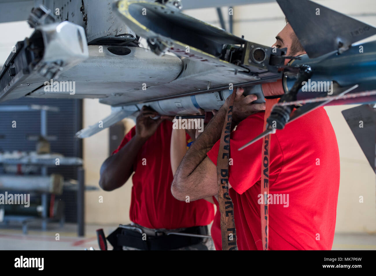 The 75th Aircraft Maintenance Unit (AMU) load crew installs an inert ...