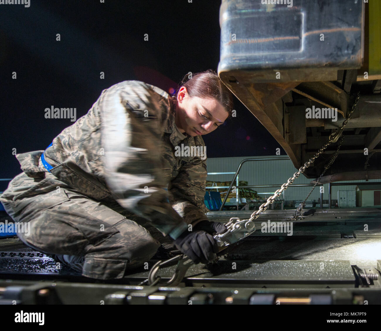 A U.S. Airman from the 60th Aerial Port Squadron secures a bus on a 60K ...