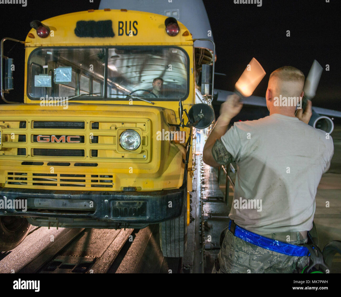 U.S. Airmen from the 60th Aerial Port Squadron load buses onto a C-5M ...