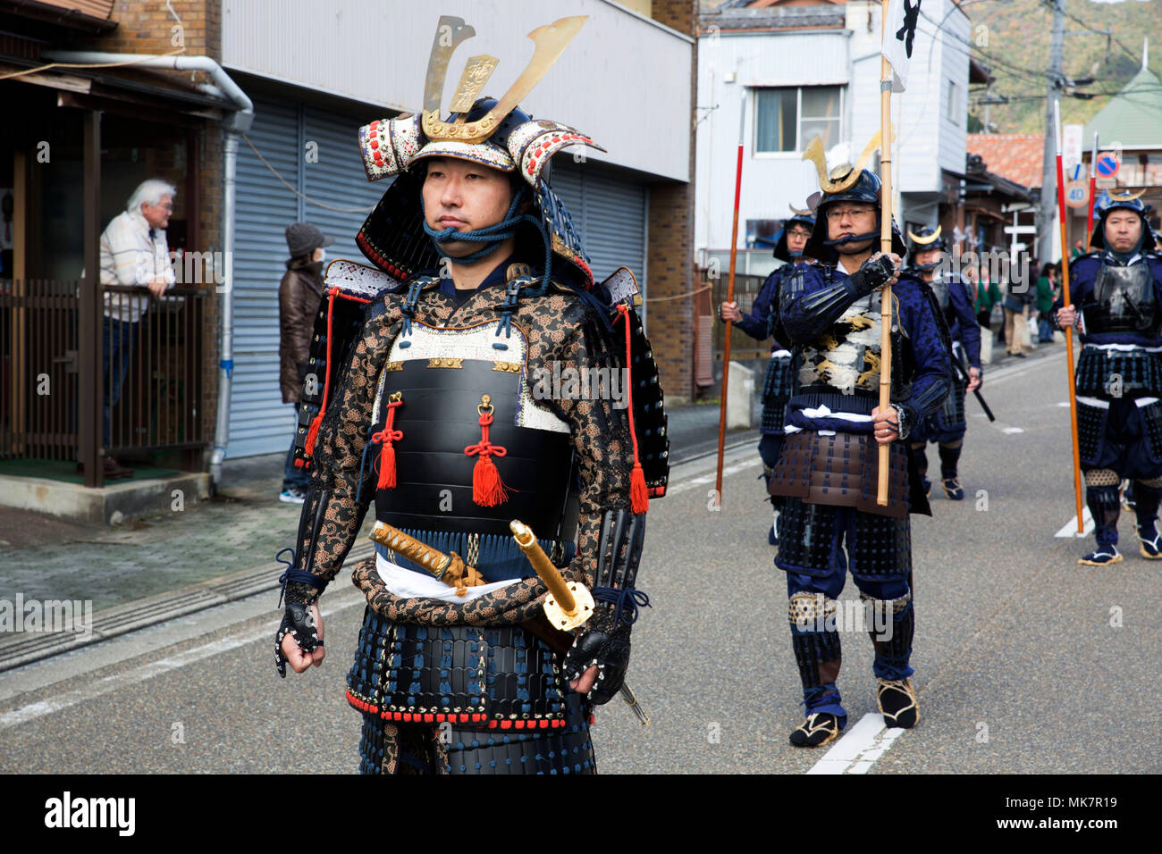 Japanese locals dressed as samurai march down the street during the ...