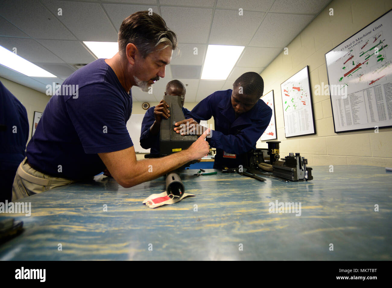 An instructor teaches African students how to assemble a Mark 19 ...