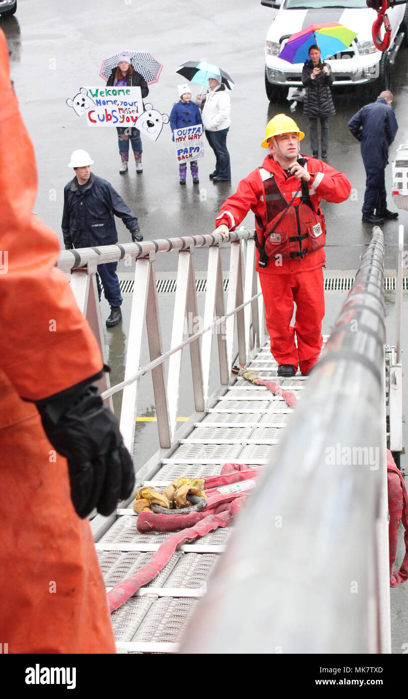 Petty Officer 1st Class David Edelson lowers the brow to the pier as ...